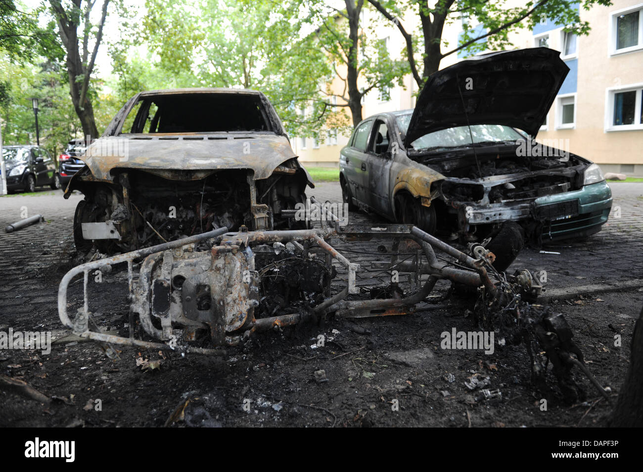A burned out Mercedes (L) and an Opel stand on a parking lot in Berlin ...