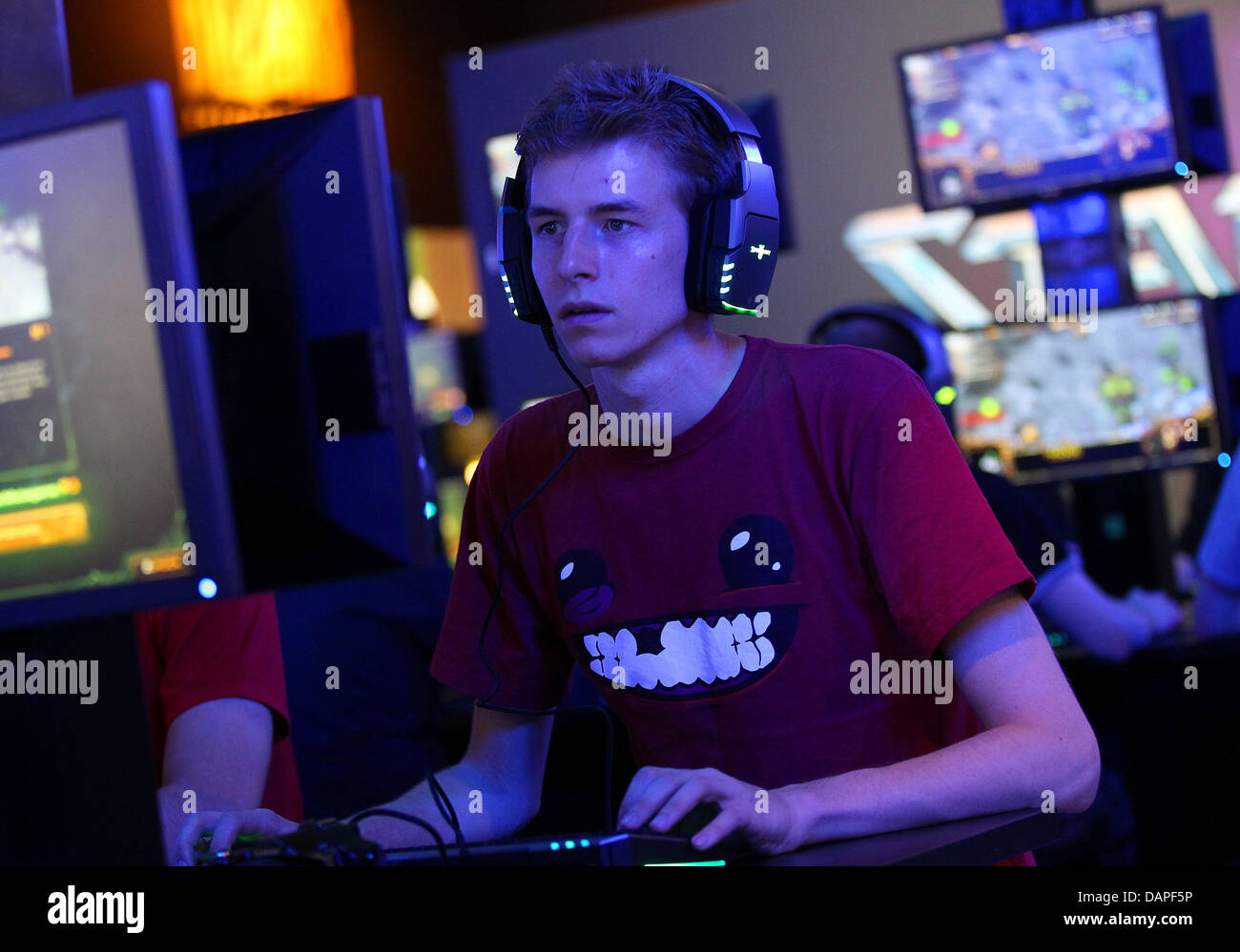 A computer gamer sits in front of a screen at the Gamescom fair in ...