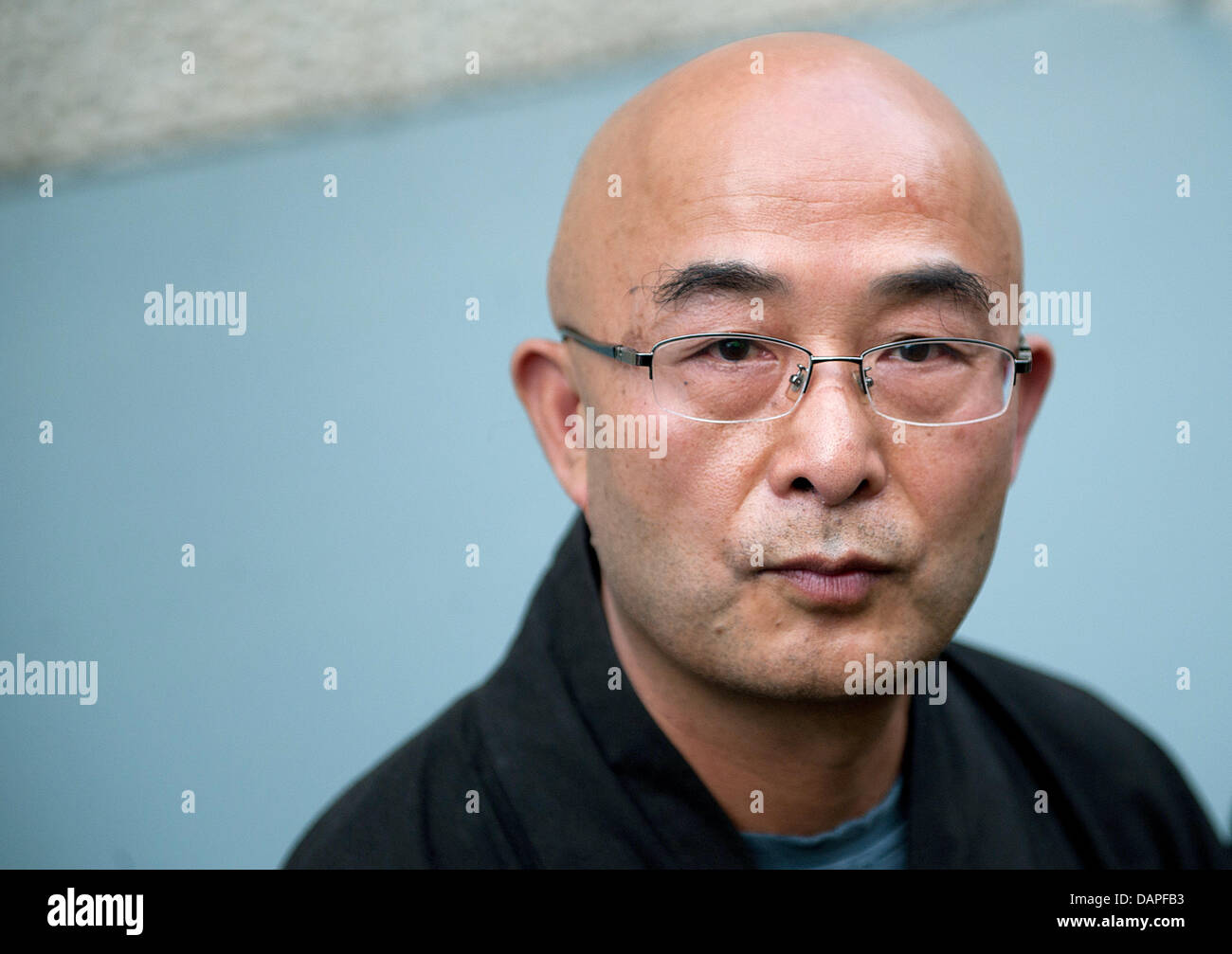 Chinese Poet And Writer Liao Yiwu Poses For A Picture During A Reading Session In Berlin