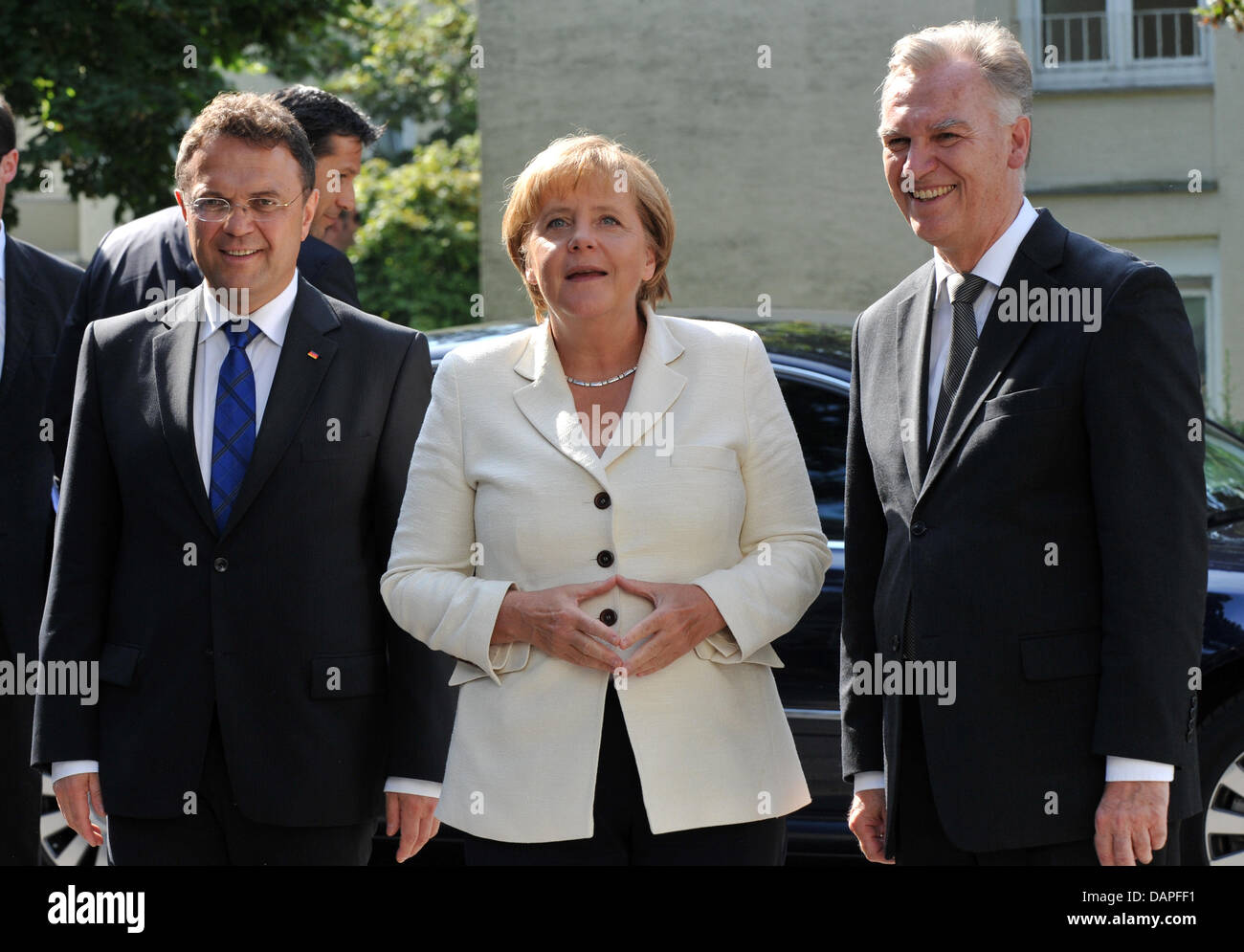 German Chancellor Angela Merkel (C) is received by the president of the ...