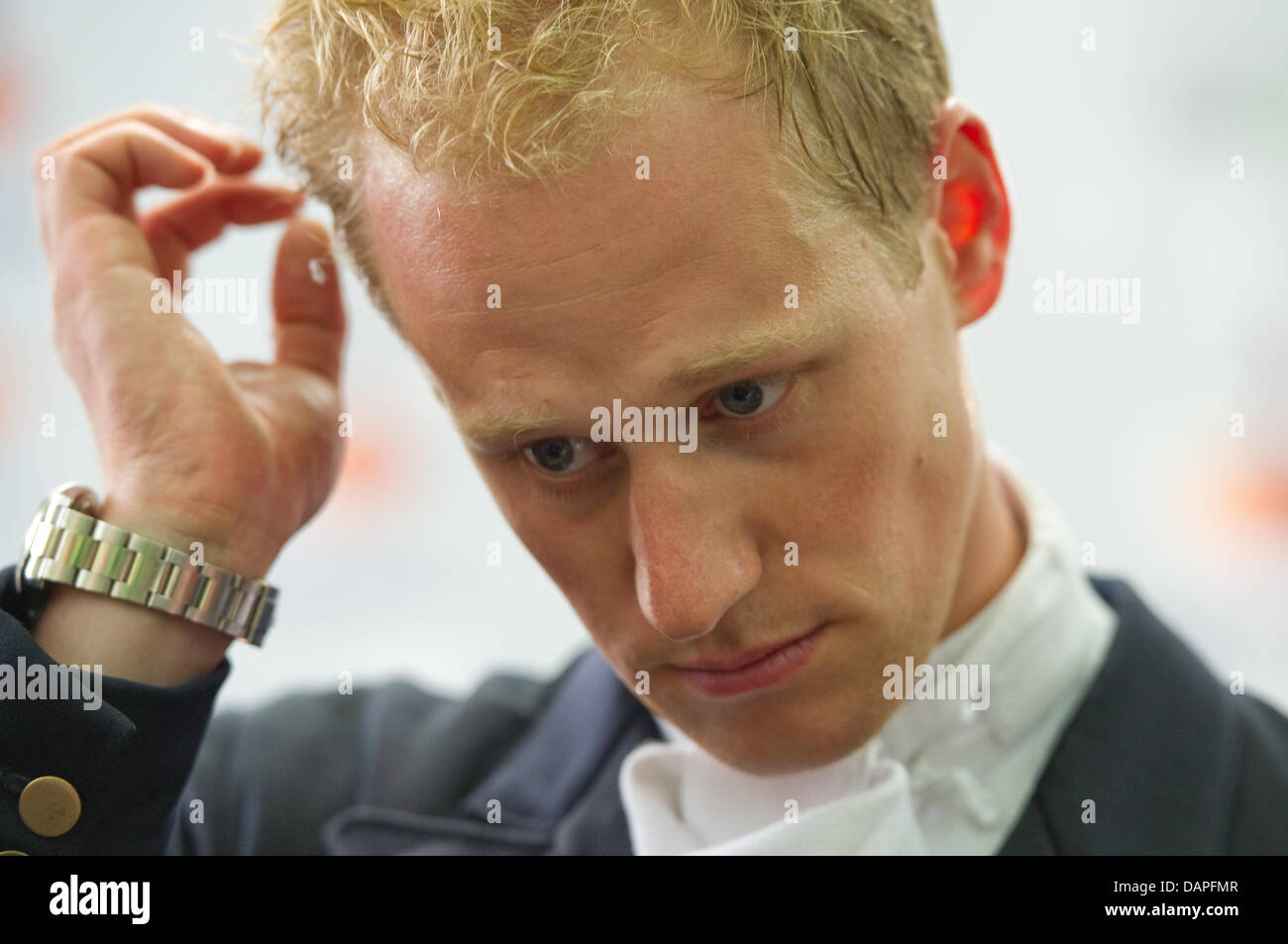 German dressage rider Matthias Alexander Rath scratches his head after ...