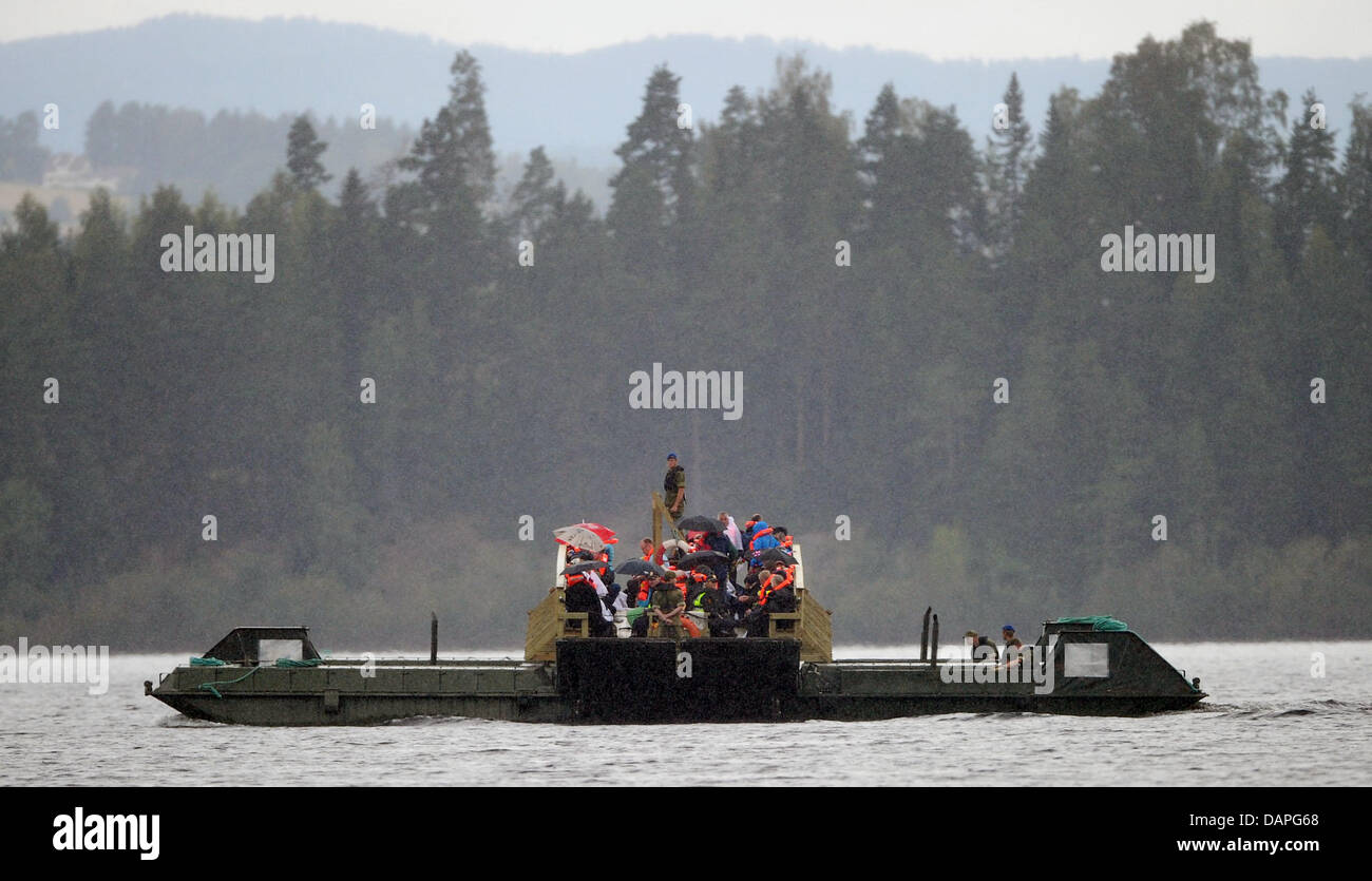 Relatives of the victims that died in the shooting stand on a ferry to ...