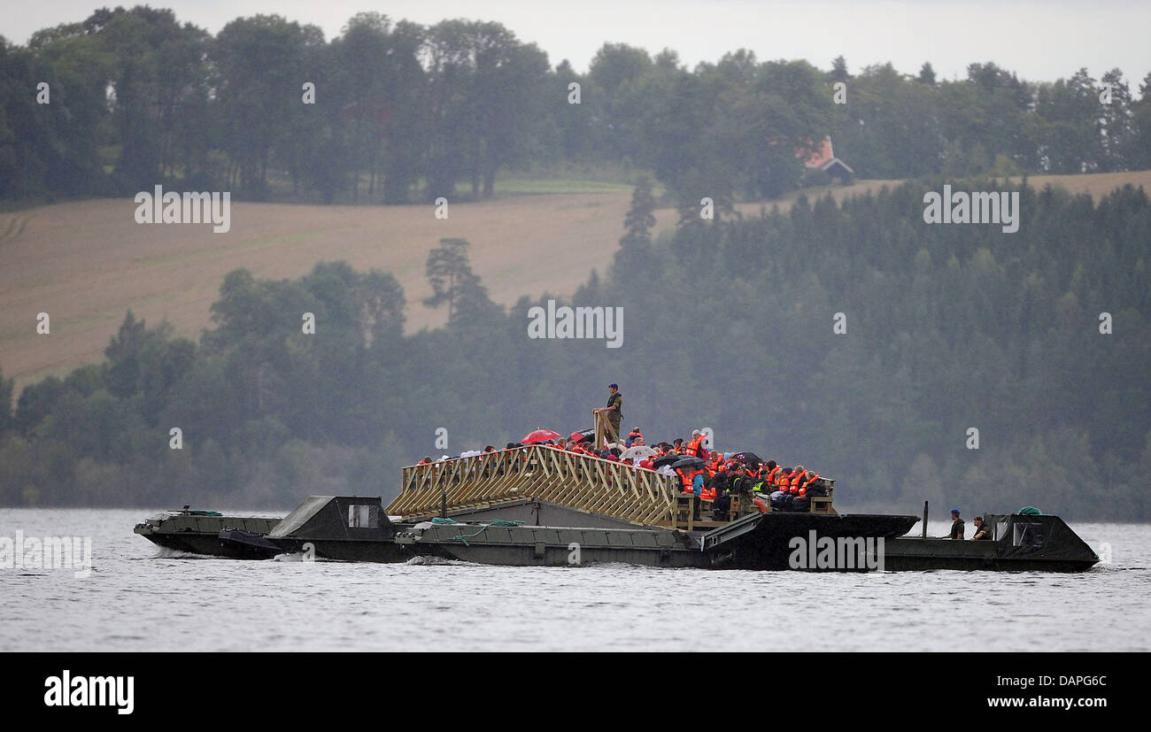 Relatives of the victims that died in the shooting stand on a ferry to ...