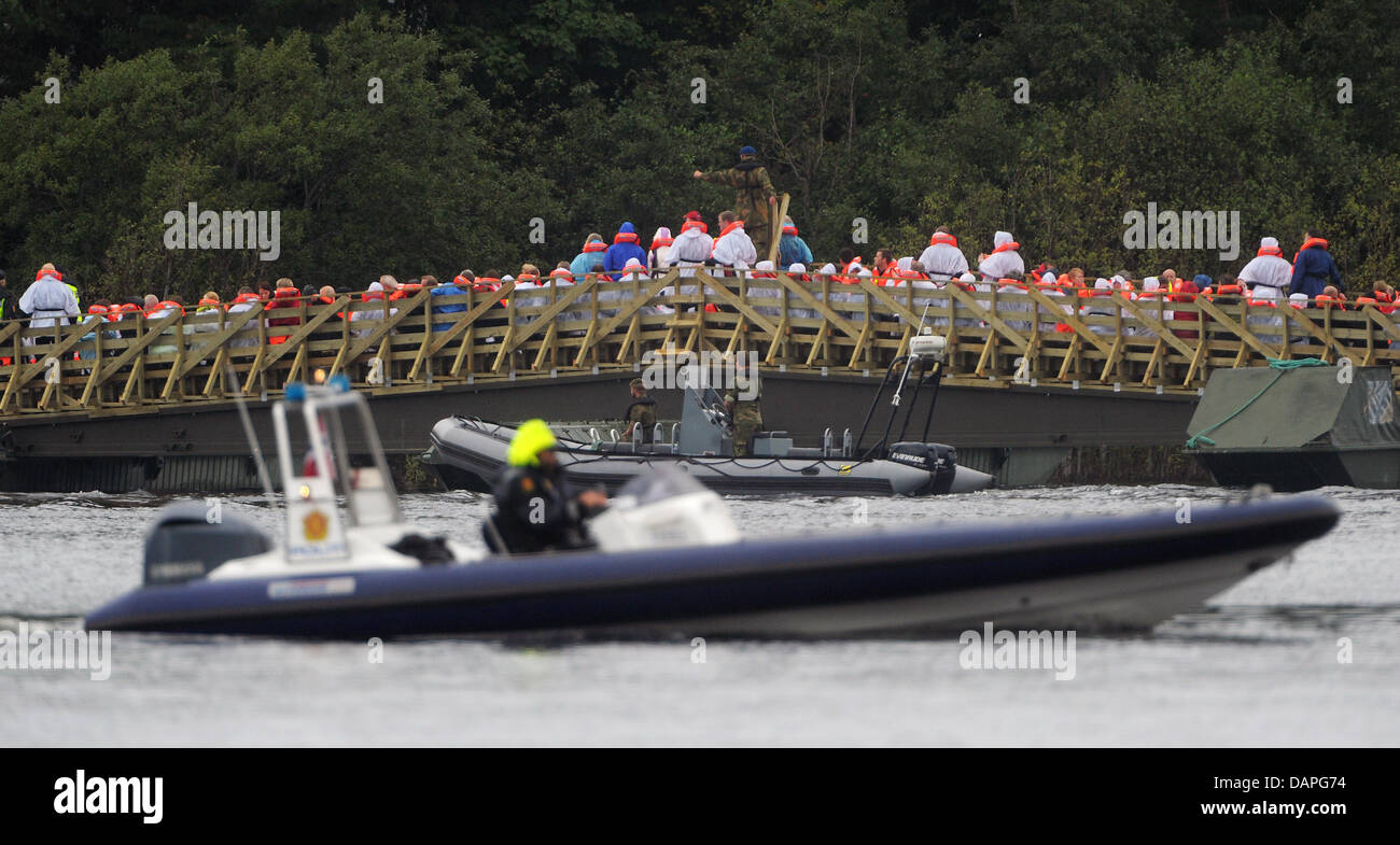 Relatives of the victims that died in the shooting stand on a ferry to ...