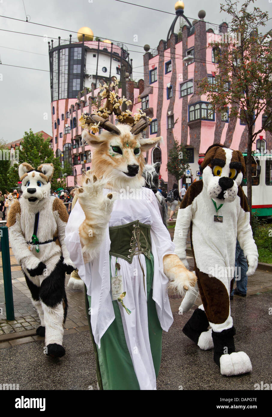 People in furry animal costumes take part in a parade during the 17th ...
