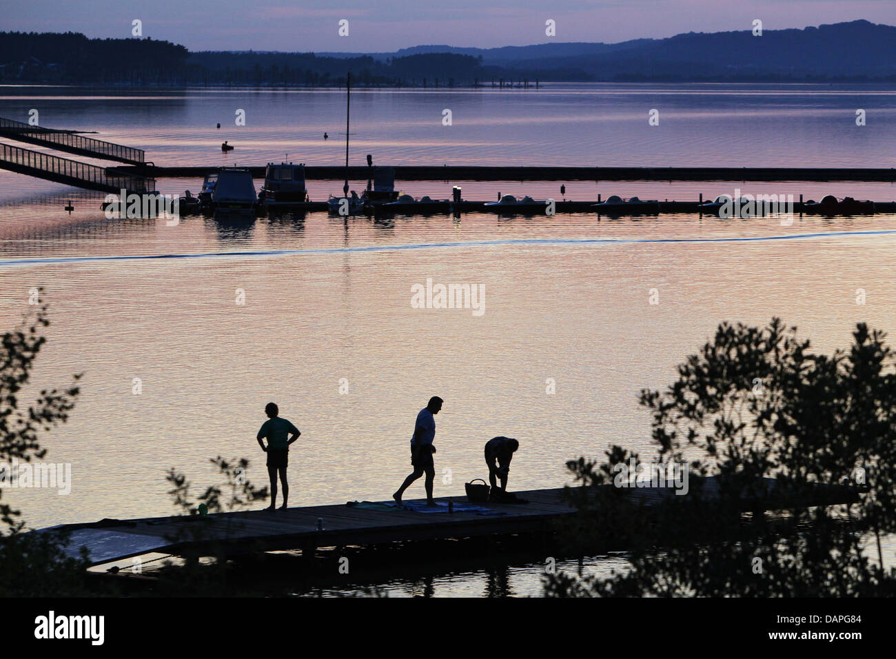 People enjoy the sunset at Lake Brombach near Pleinfeld, Germany, 18 ...