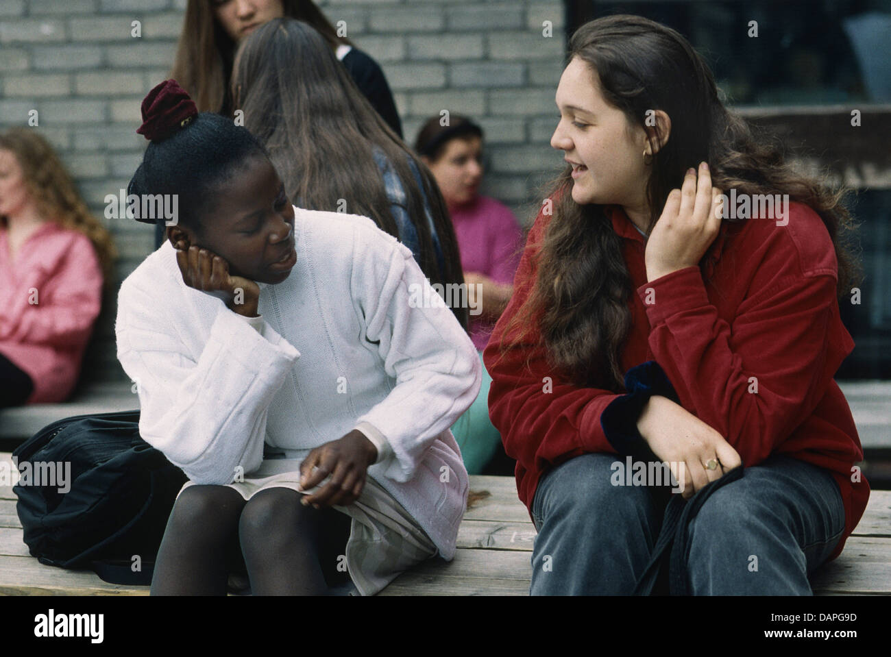 teenagers talking outside in school grounds Stock Photo - Alamy
