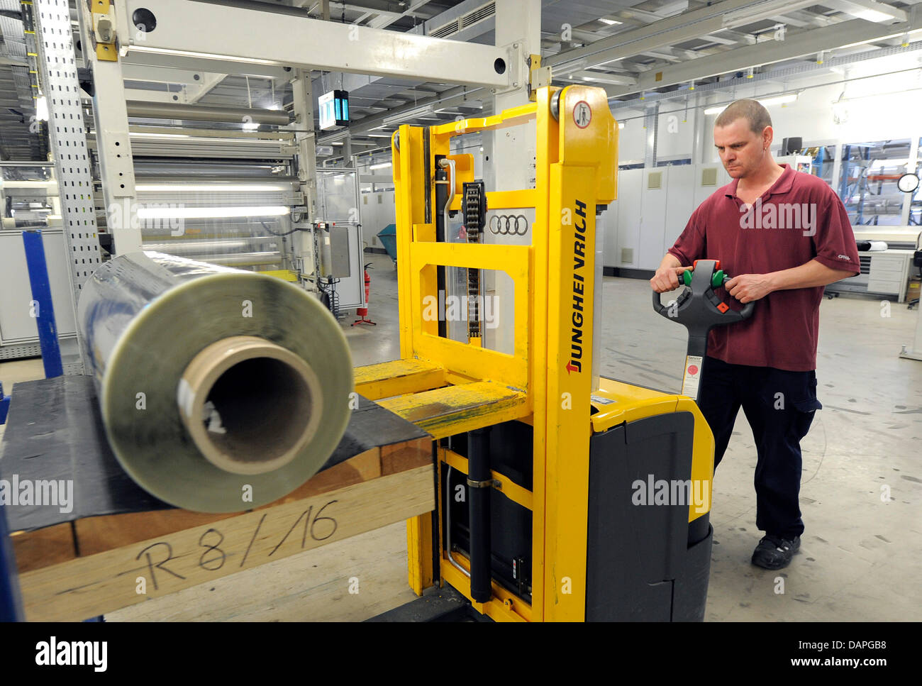 An Orafol Europe employee maneuvers foil through the production site in ...