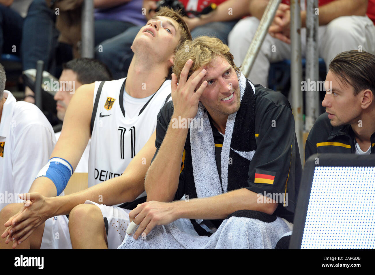 German basketball player Dirk Nowitzki (C) talks his teammate Tibor ...
