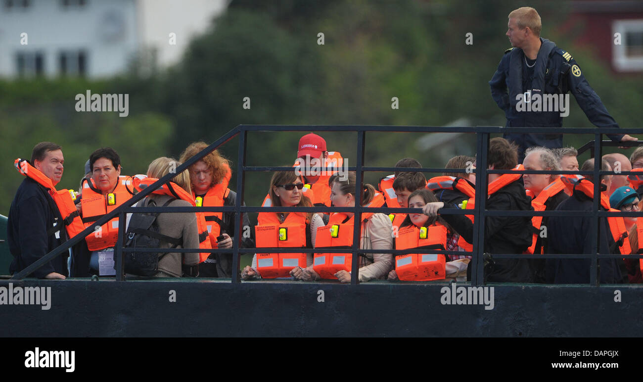 Survivors of the Utoya massacre arrive on a boat on the island of Utoya ...