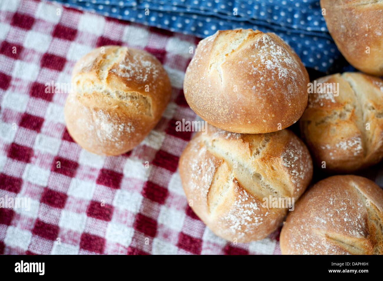Crusty, rustic rolls, home baked, straight from the oven. Blue and red ...