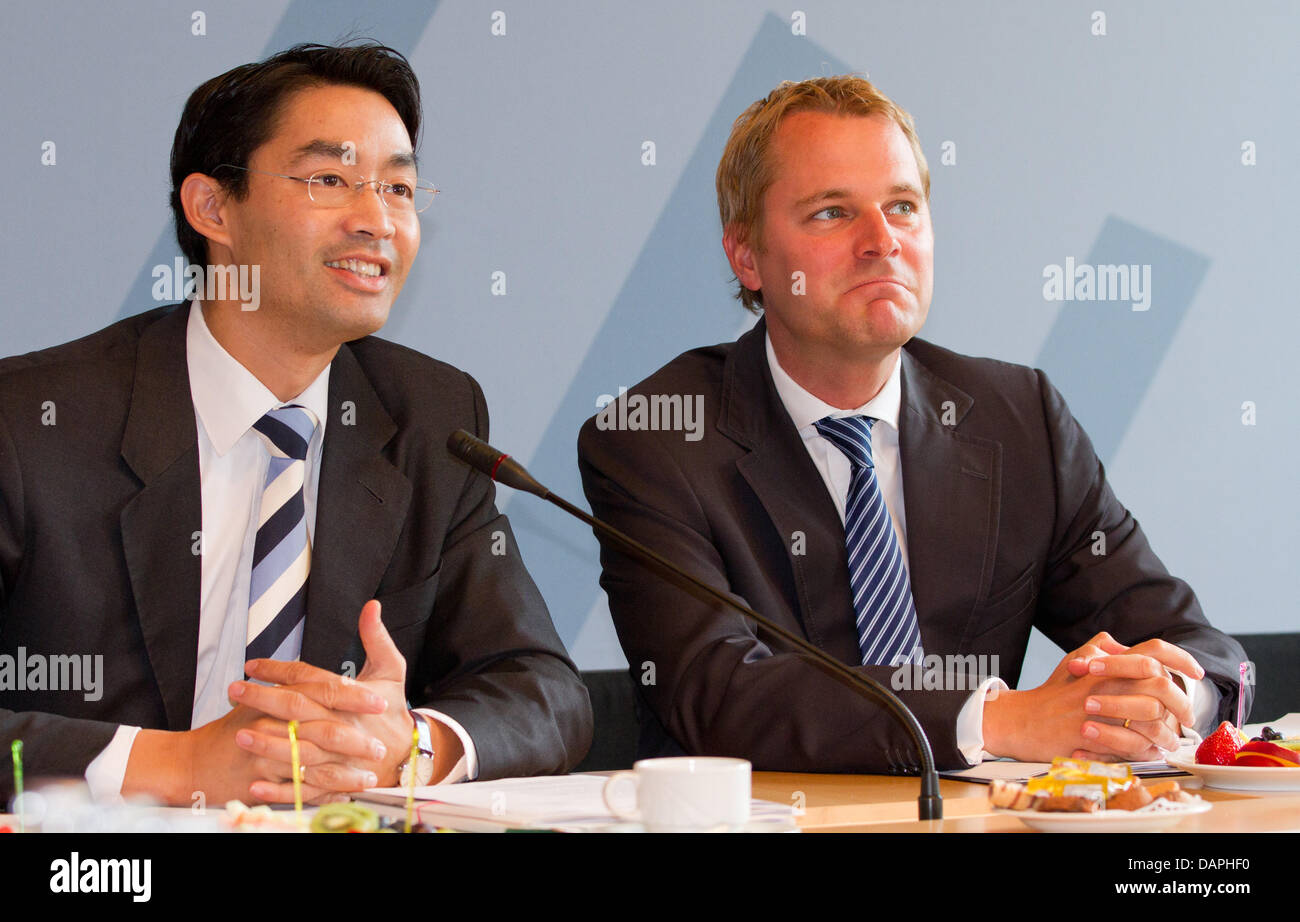 Federal health minister Daniel Bahr (R) and Federal economy minister ...