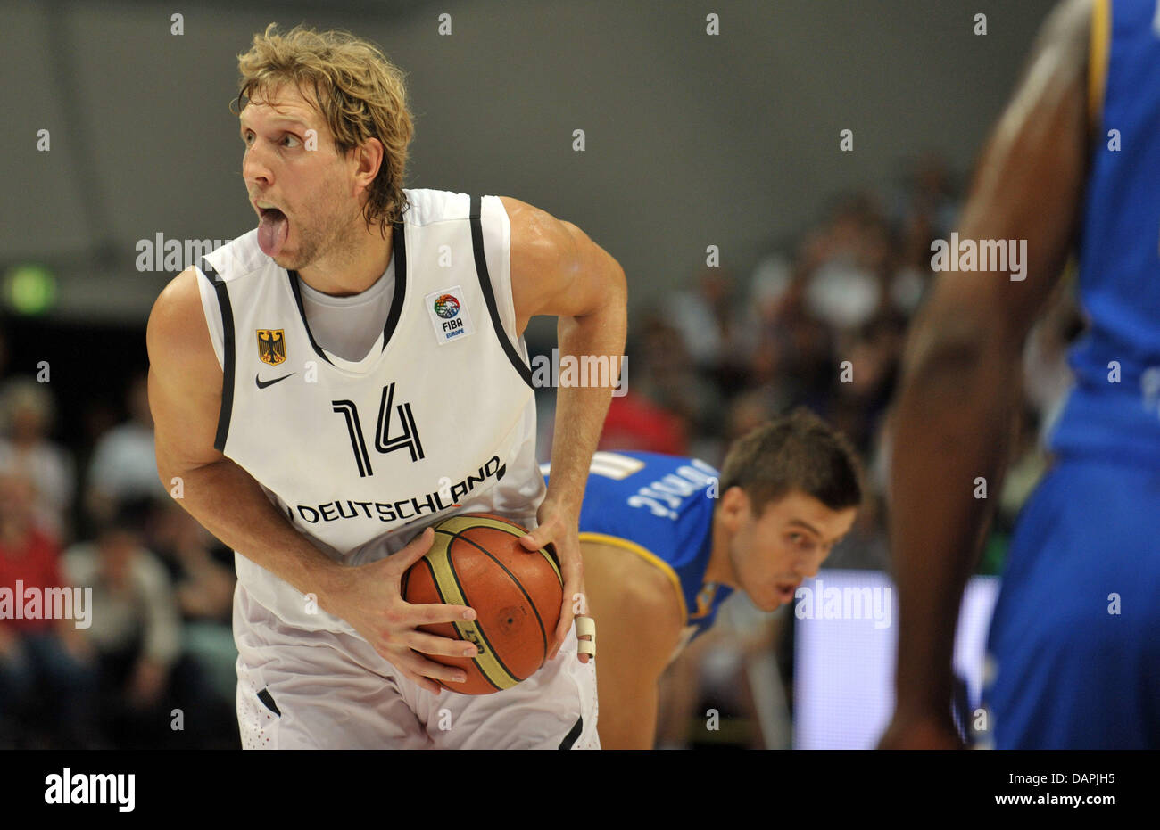 German basketball player Dirk Nowitzki (L) starts a jump shot during ...