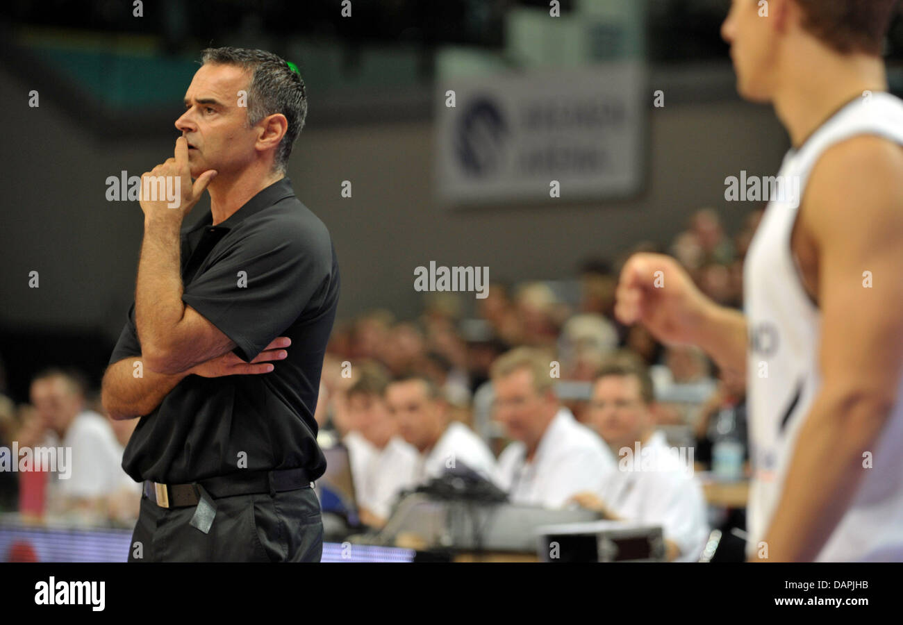 German national basketball team coach Dirk Bauermann (L) watches his ...