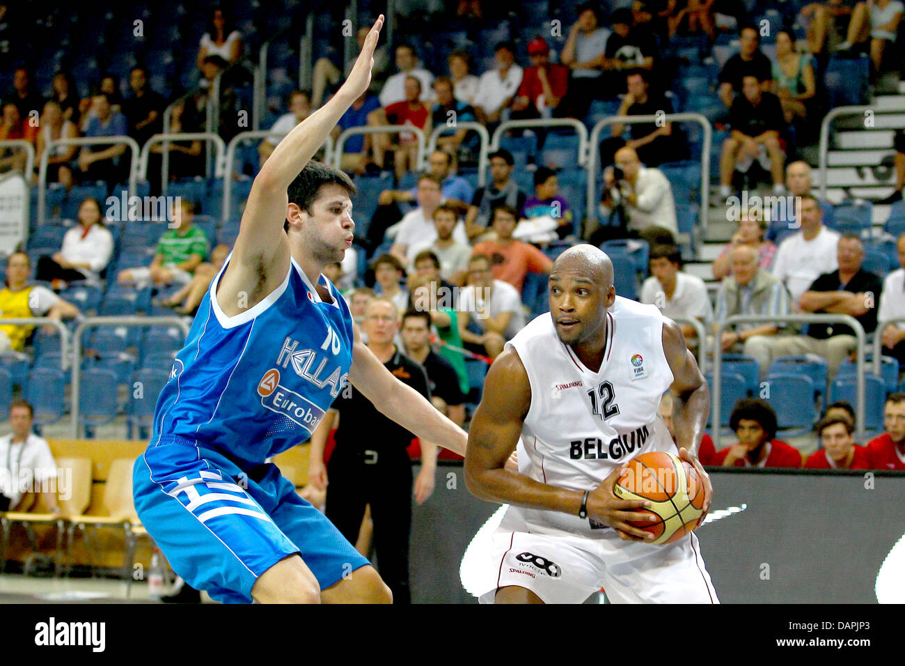 Belgium's national basketball player Marcus Faison (R) tries to score ...