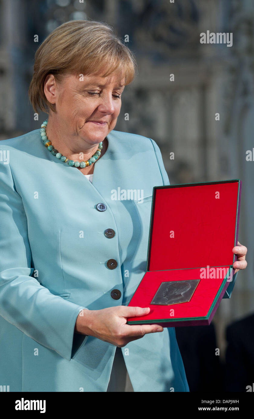 German Chancellor Angela Merkel holds the medal of the Kaiser Otto ...