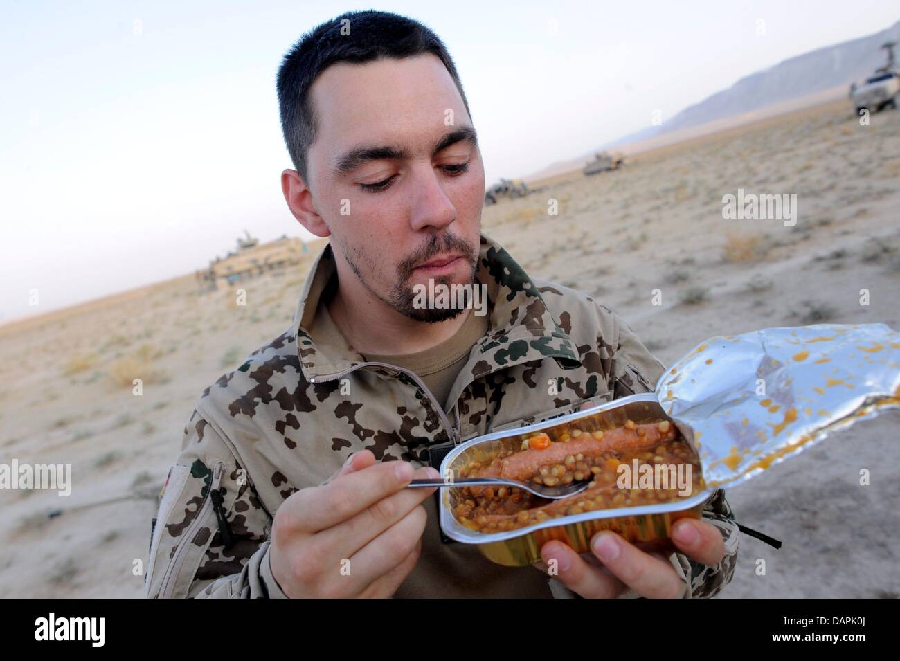 A German Armed Forces soldier prepares for spending the night in the ...