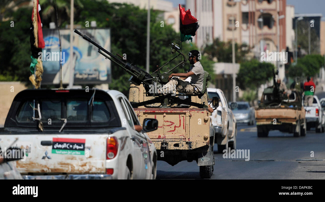 Armed rebels provide security as members of the Transitional National ...