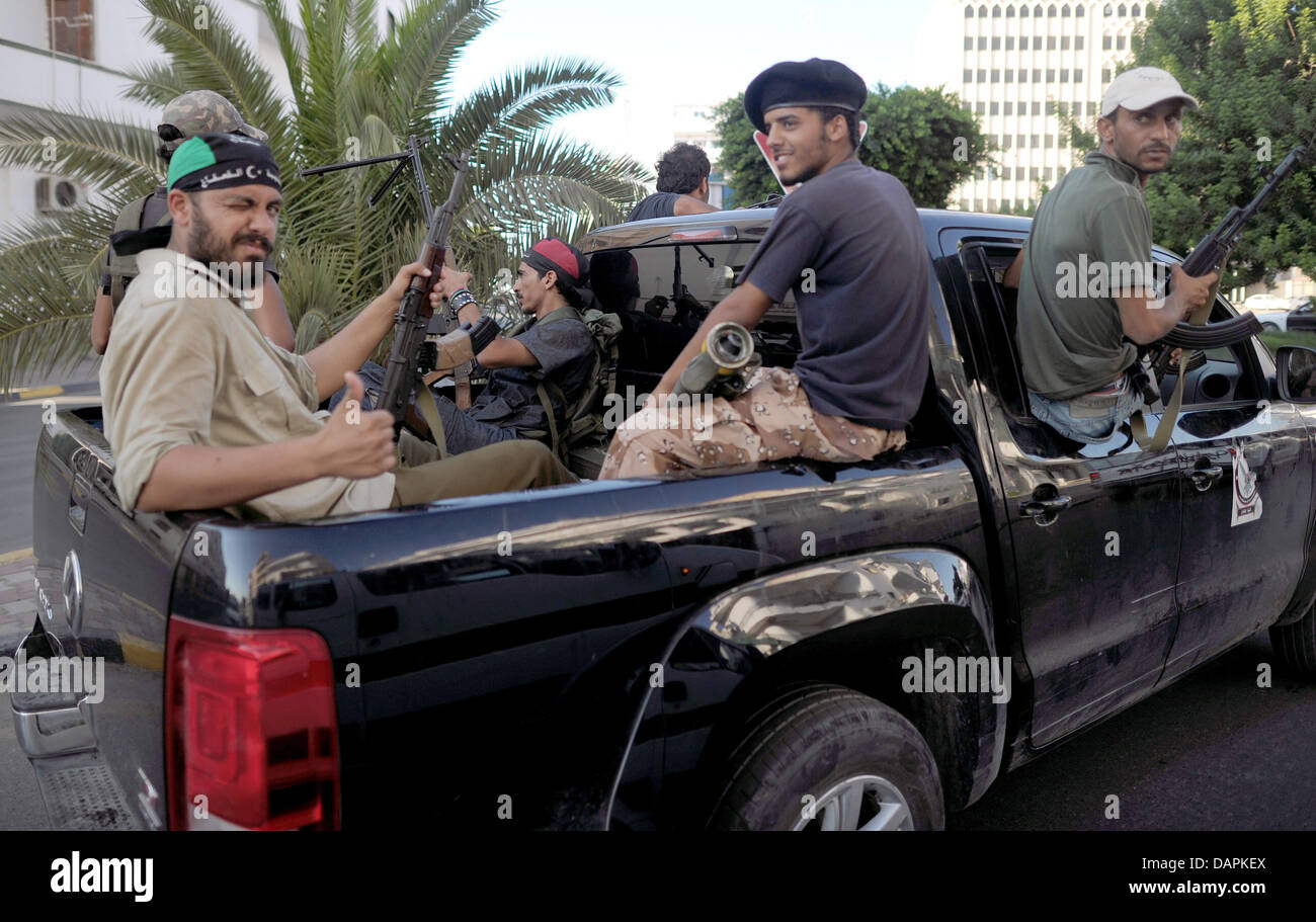 Armed rebels provide security as members of the Transitional National ...