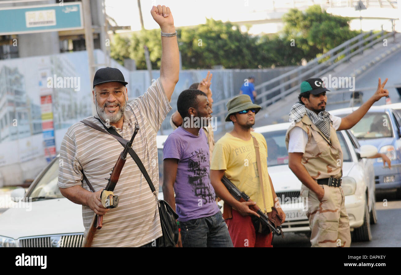 Armed rebels cheer as members of the Transitional National Council (TNC ...