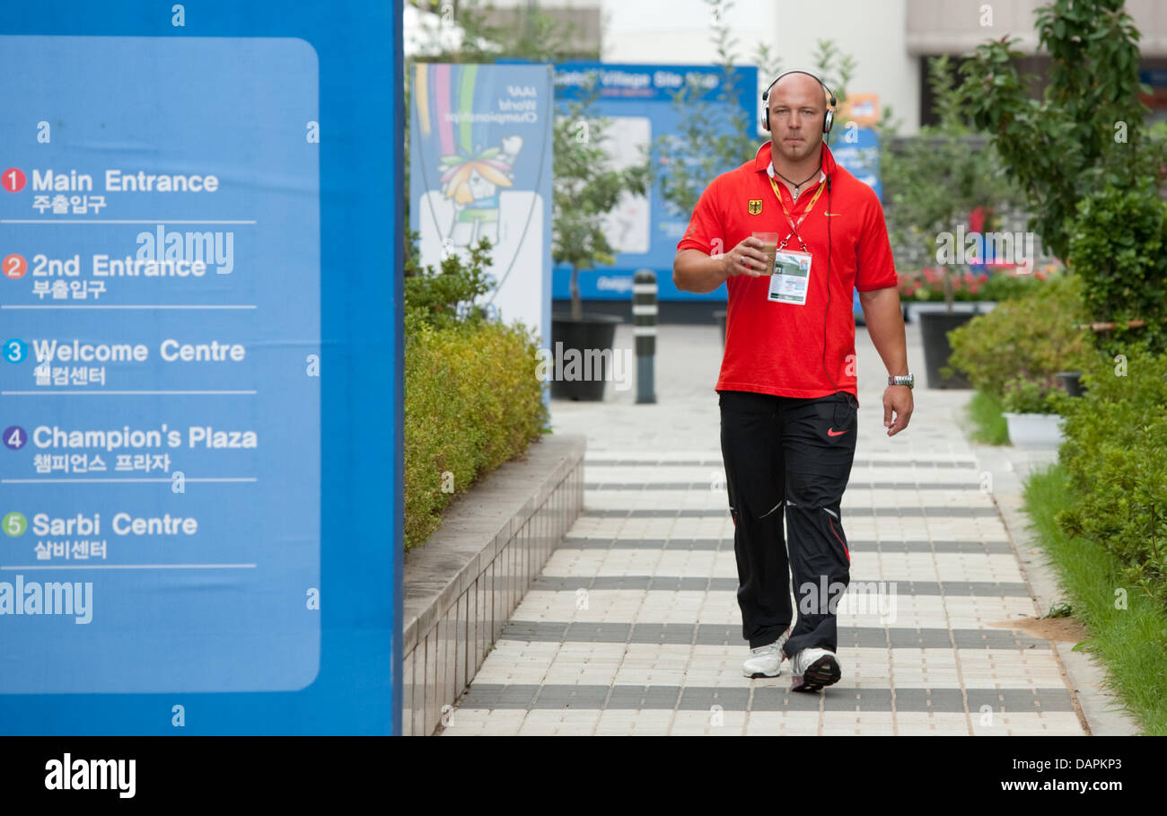 German hammer thrower Markus Esser leaves the athlete's village to take ...