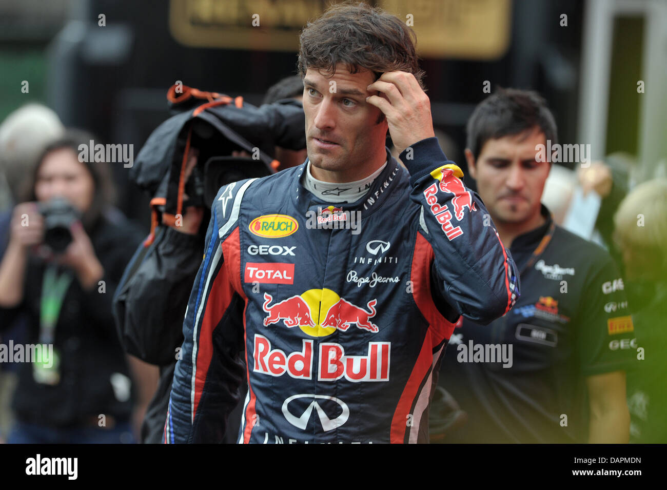 Australian Formula One driver Mark Webber of Red Bull walks through the ...