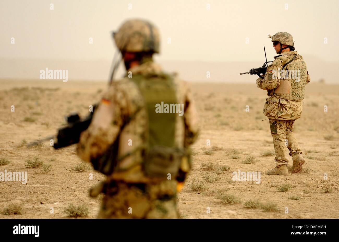 Two Bundeswehr soldiers roam through the desert during a minesweeping ...