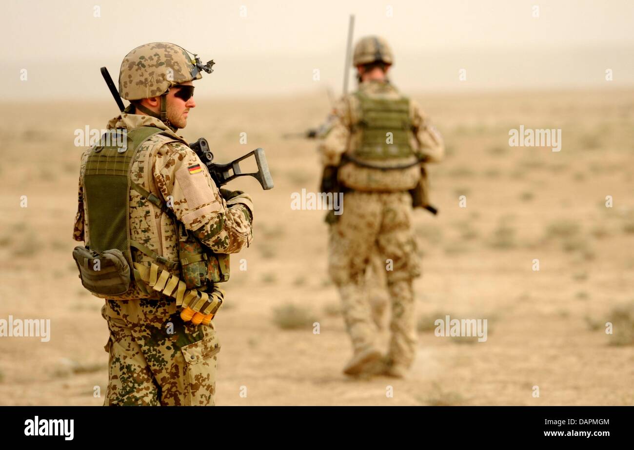 Two Bundeswehr soldiers roam through the desert during a minesweeping ...