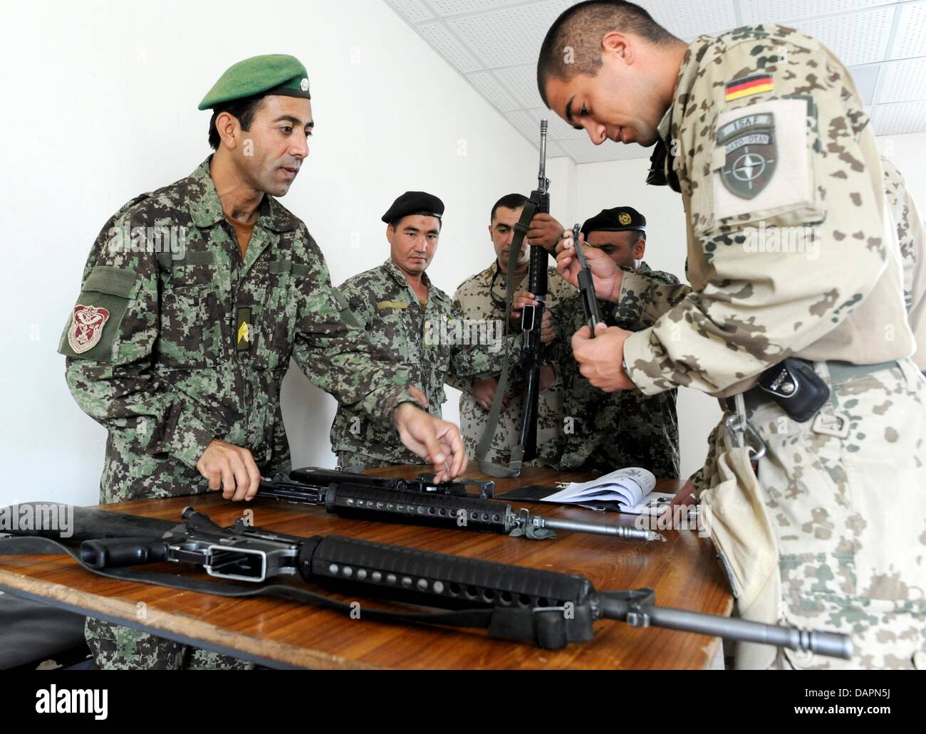 Soldiers from the Afghan National Army (ANA) are trained how to use ...