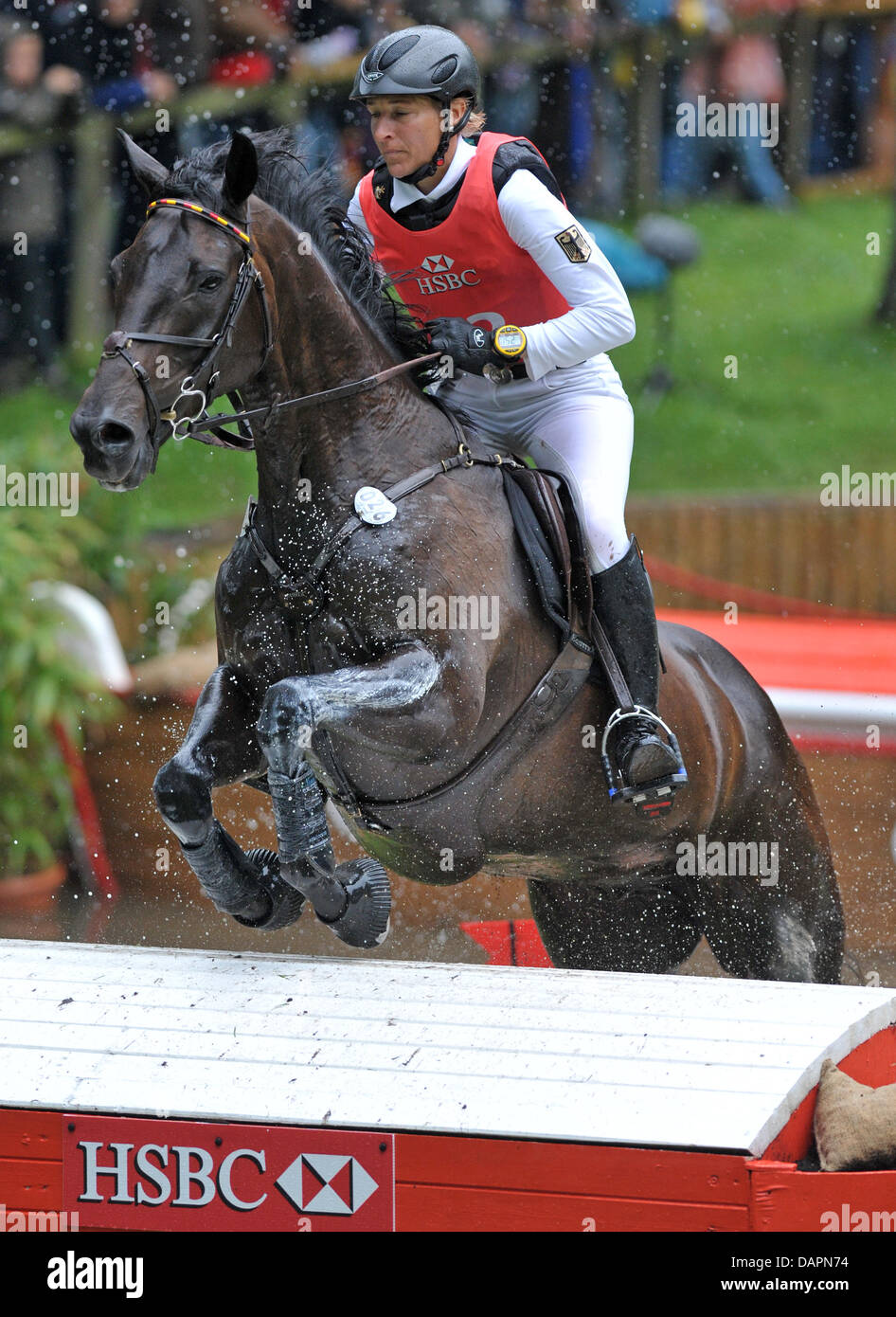 German eventing rider Ingrid Klimke jumps over an obstacle on her horse ...