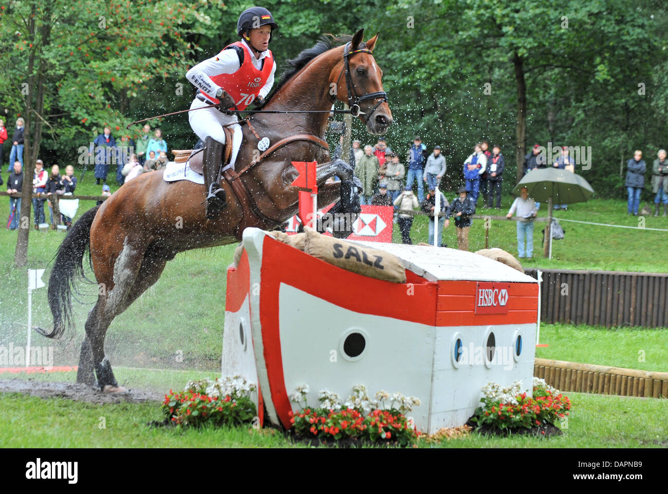 German eventing rider Michael Jung jumps over an obstacle on his horse ...