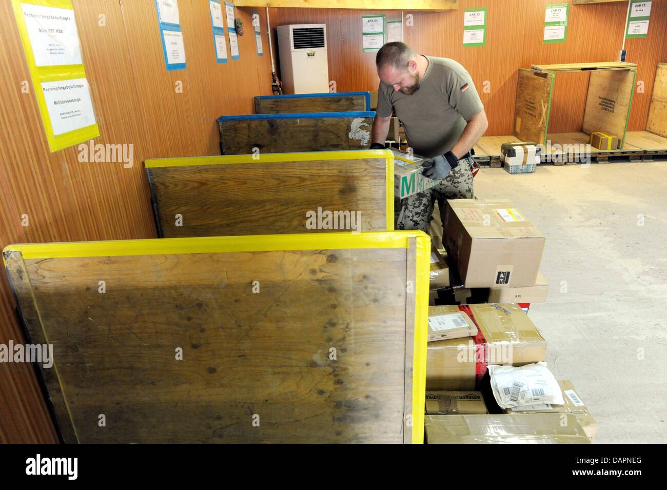 A Bundeswehr soldier assorts parcels at the German army postal service ...