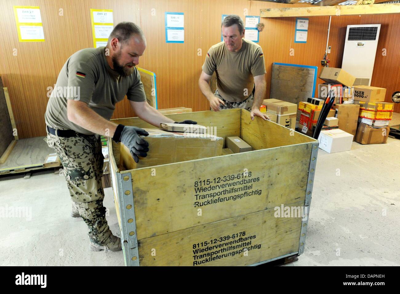 Bundeswehr soldiers assort parcels at the German army postal service ...