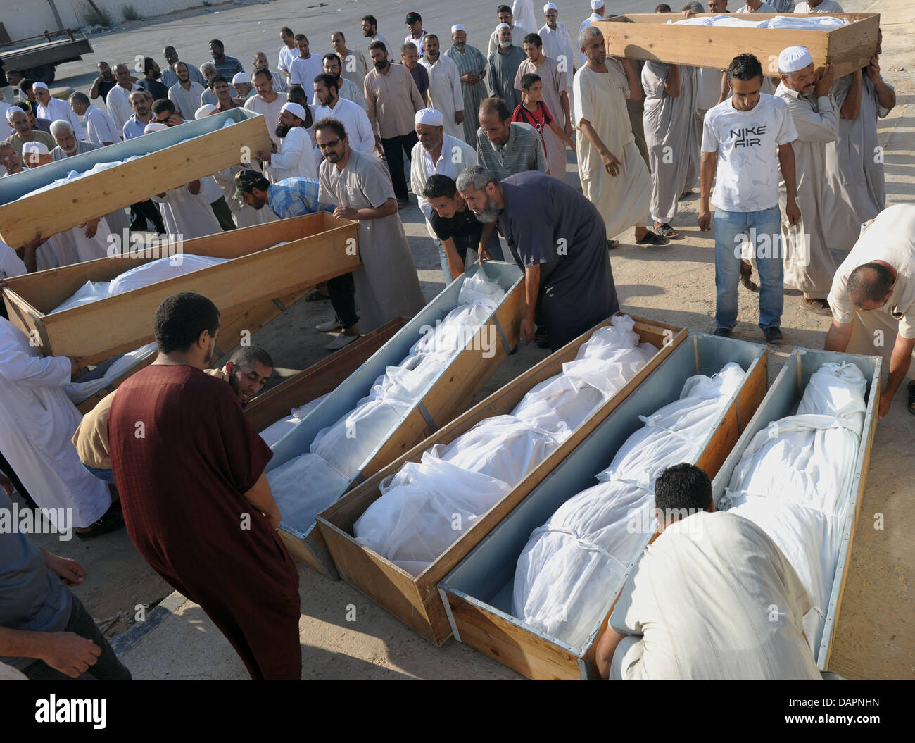 People attend a funeral in Tripoli, Libya, on 27 August 2011. Rebels ...