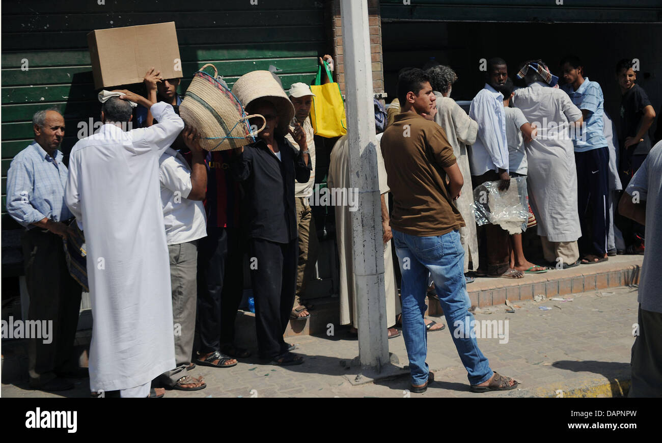 People queue for bread on Saturday, 28 August 2011 in a street in ...