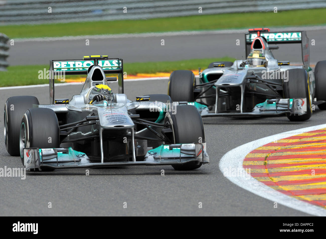 German Formula One driver Michael Schumacher (R) of Mercedes GP tries ...