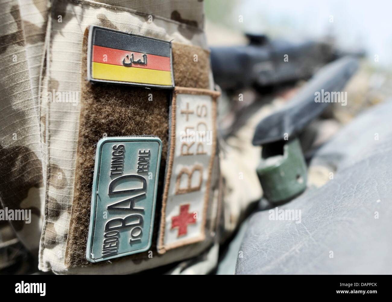 A Bundeswehr soldier wears a 'We do bad things to bad people' button on ...