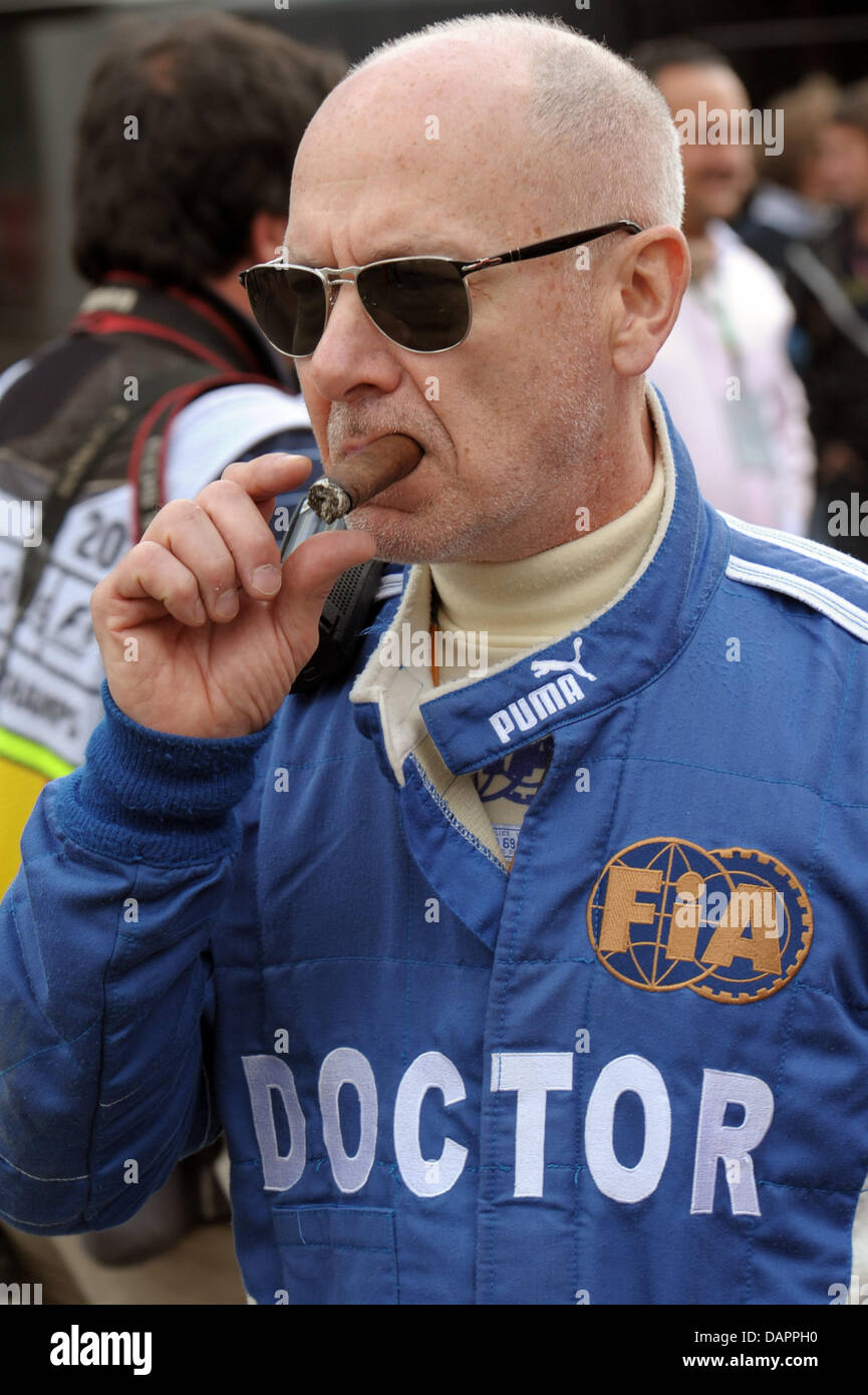 FIA doctor Gary Hartstein smokes a cigar in the paddock at the race ...
