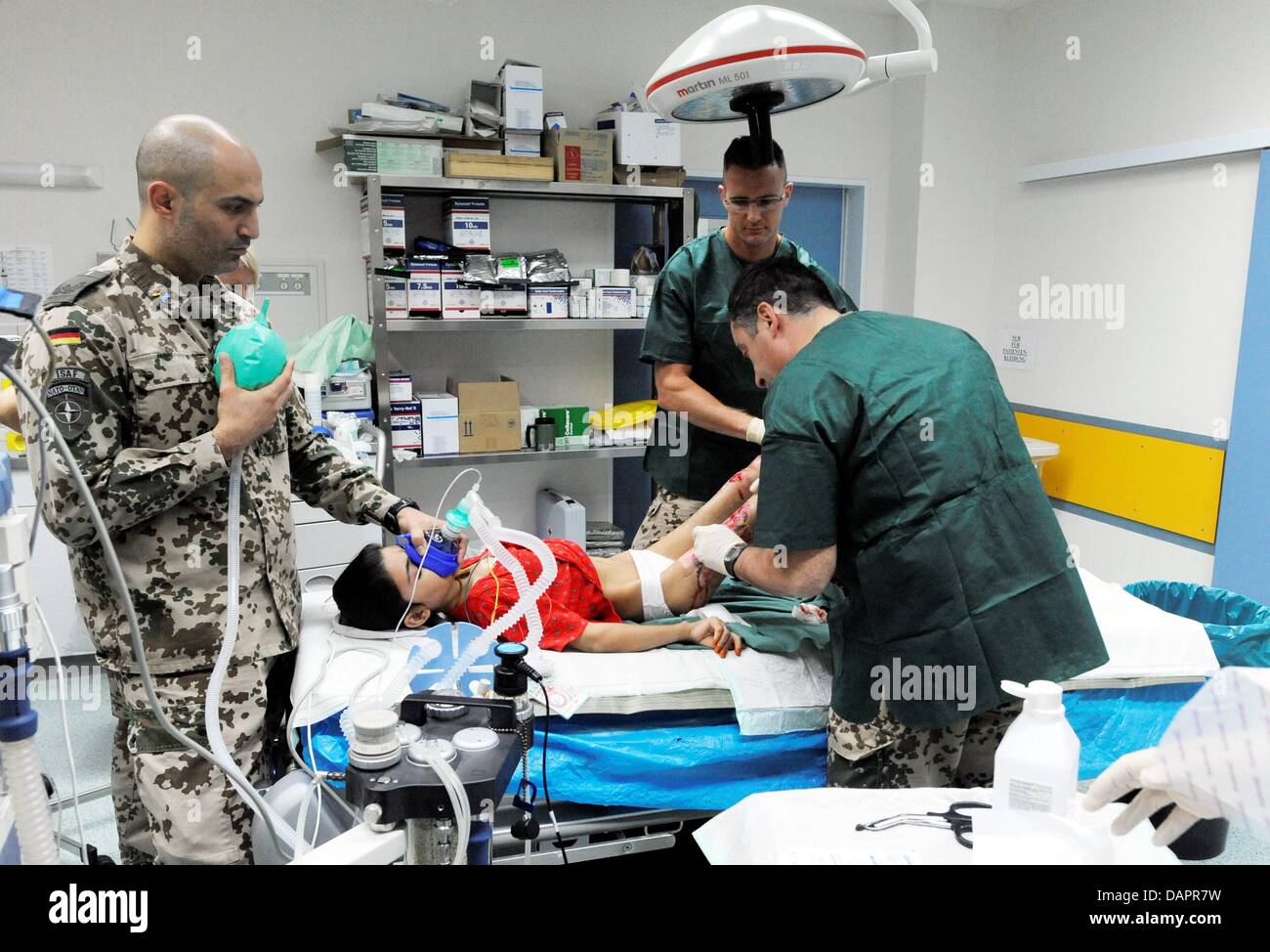Army doctors of the German Bundeswehr treat a small Afghan girl, who ...