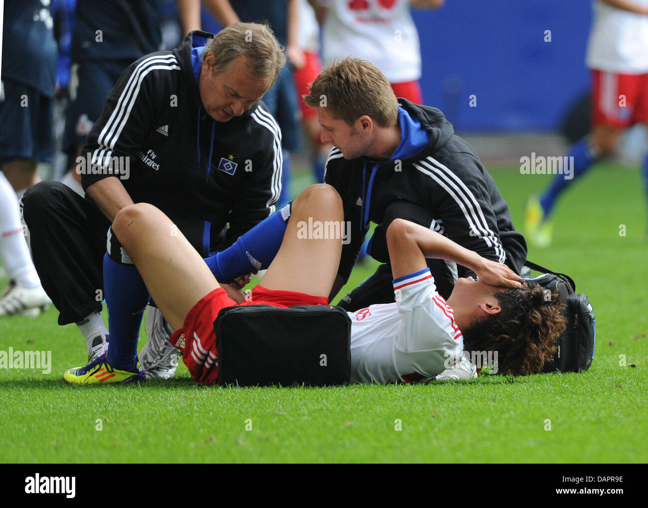 Hamburg's Heung-Min Son is treated by the physios during the Bundesliga ...