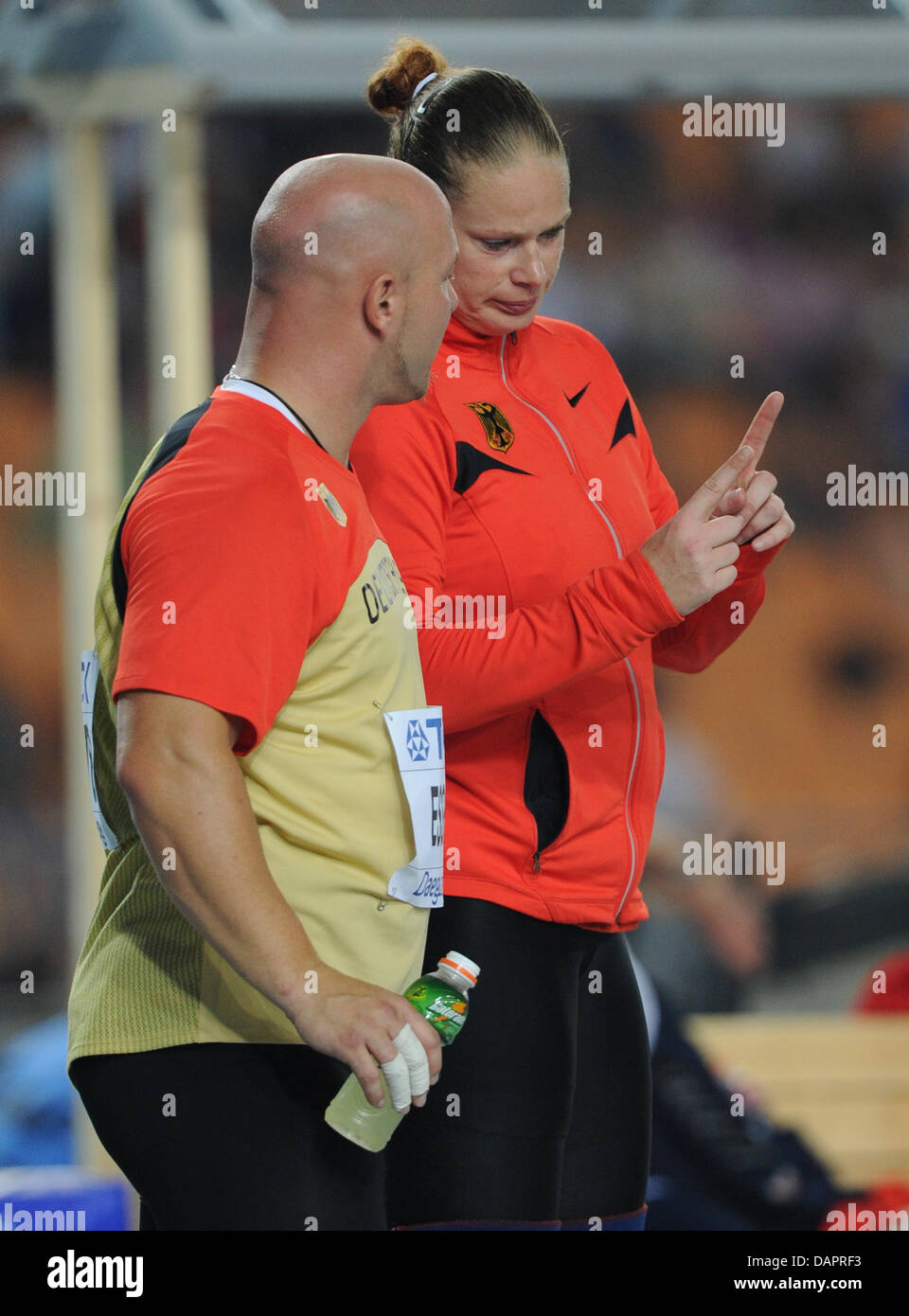 Markus Esser of Germany talks to shot-putter Nadine Kleinert of Germany ...
