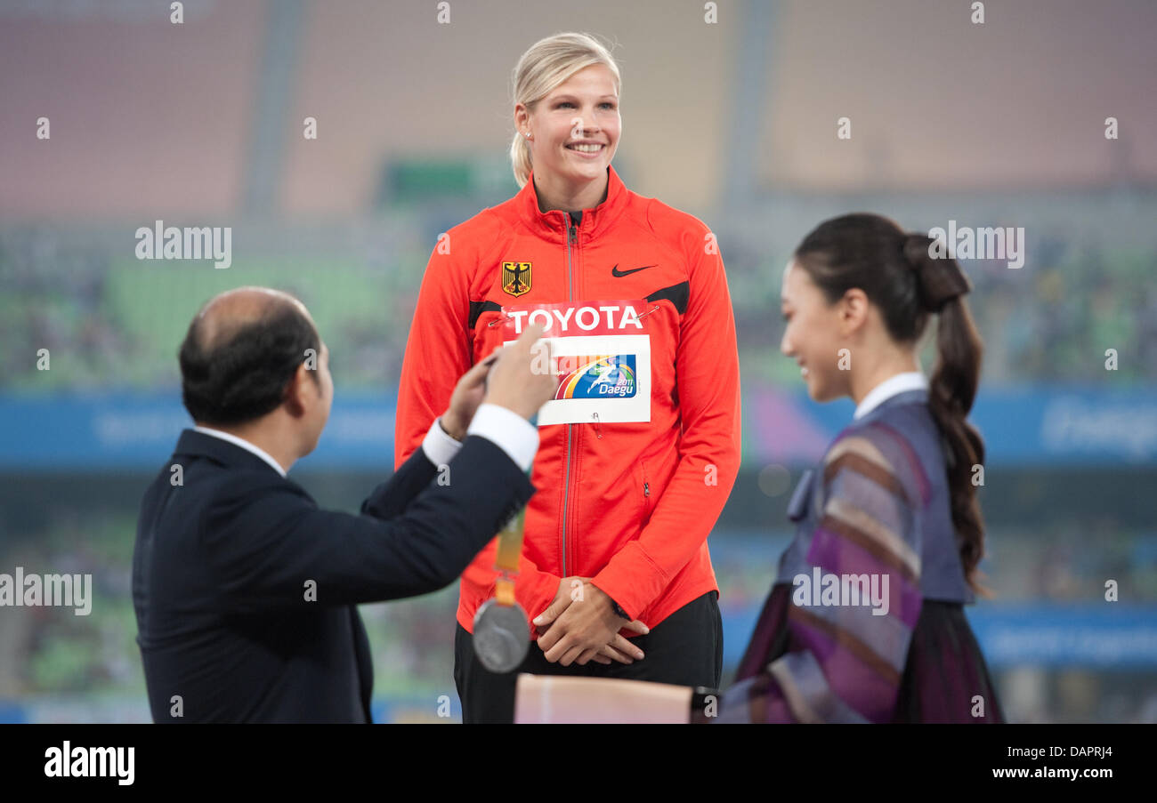 Nadine Mueller (C) of Germany recieves her silver medal during the ...