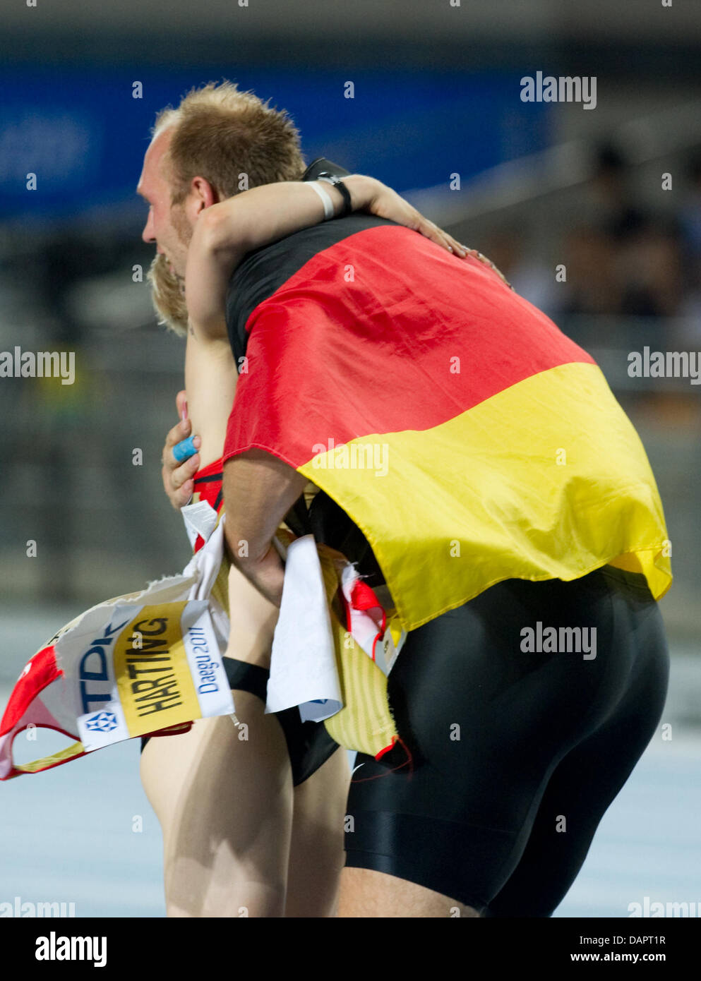 Martina Strutz (L) and Robert Harting of Germany hug each other after ...