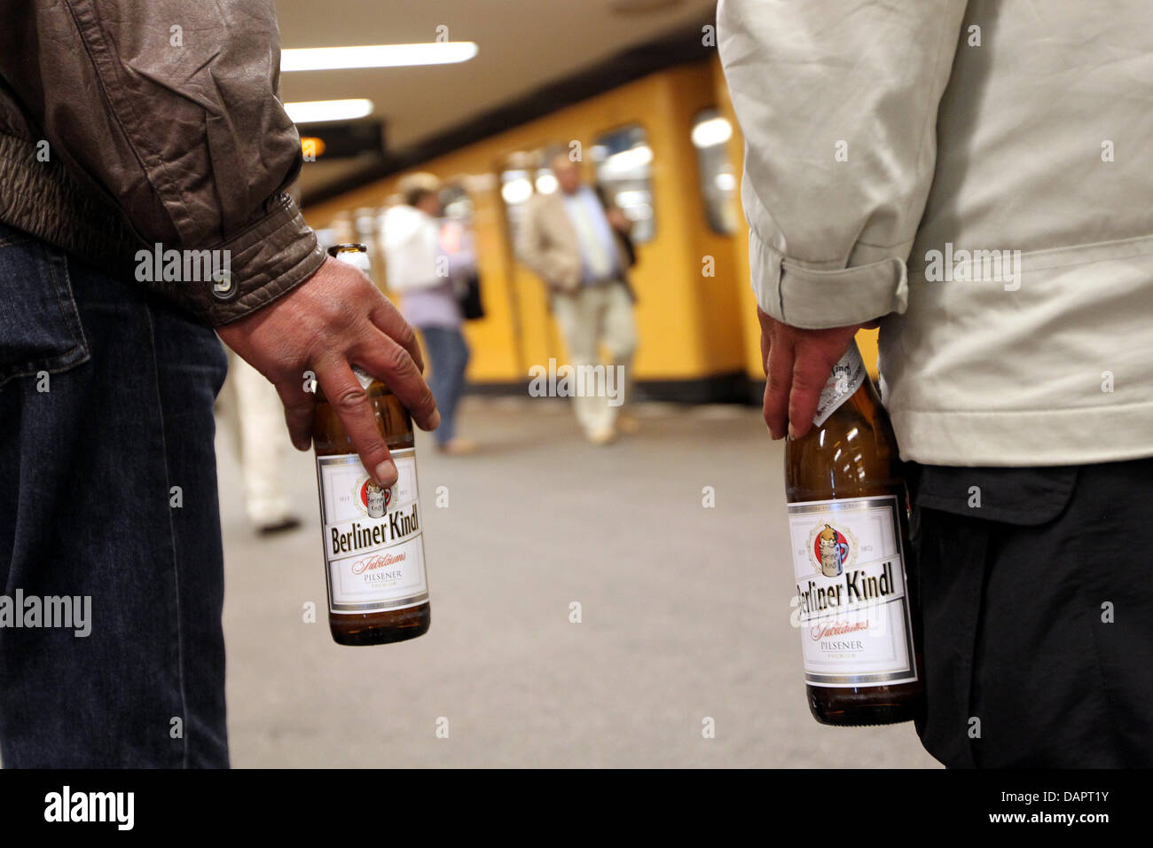 Two men carry beer bottles at the subway station Zoologischer Garten in ...