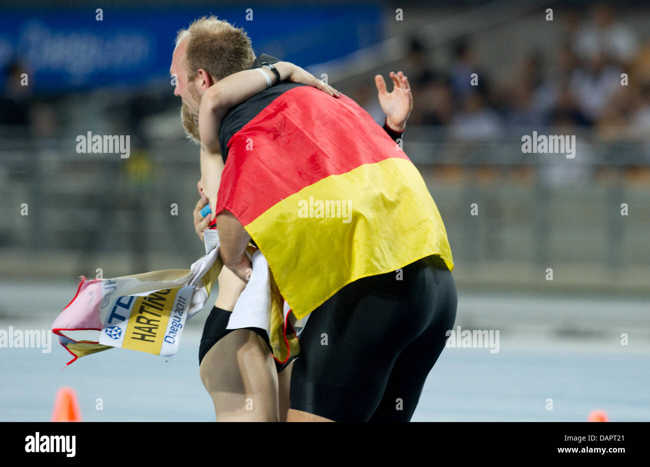 Martina Strutz (L) and Robert Harting of Germany hug each other after ...