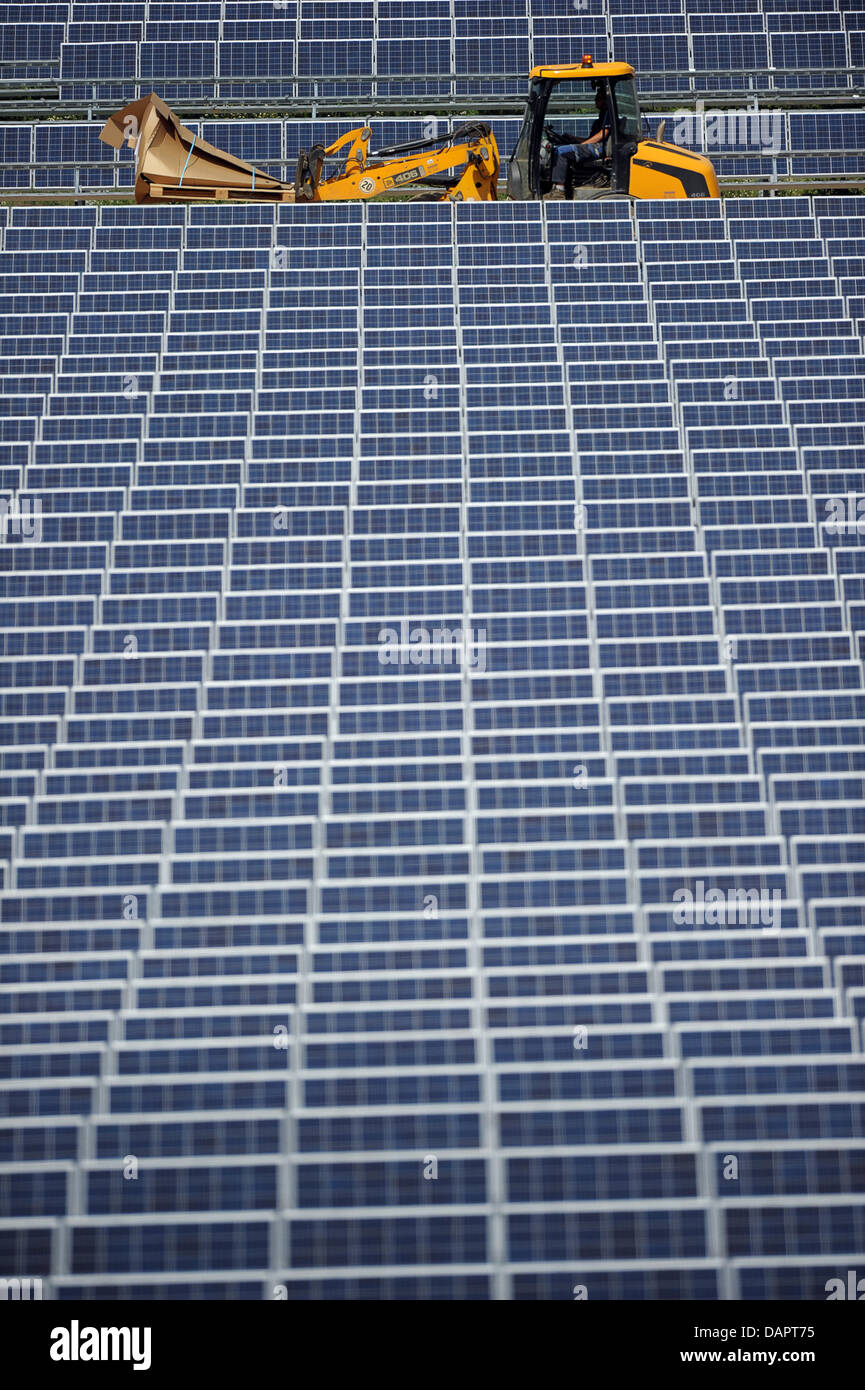 An excavator drives through the construction site of the Solar Park in ...