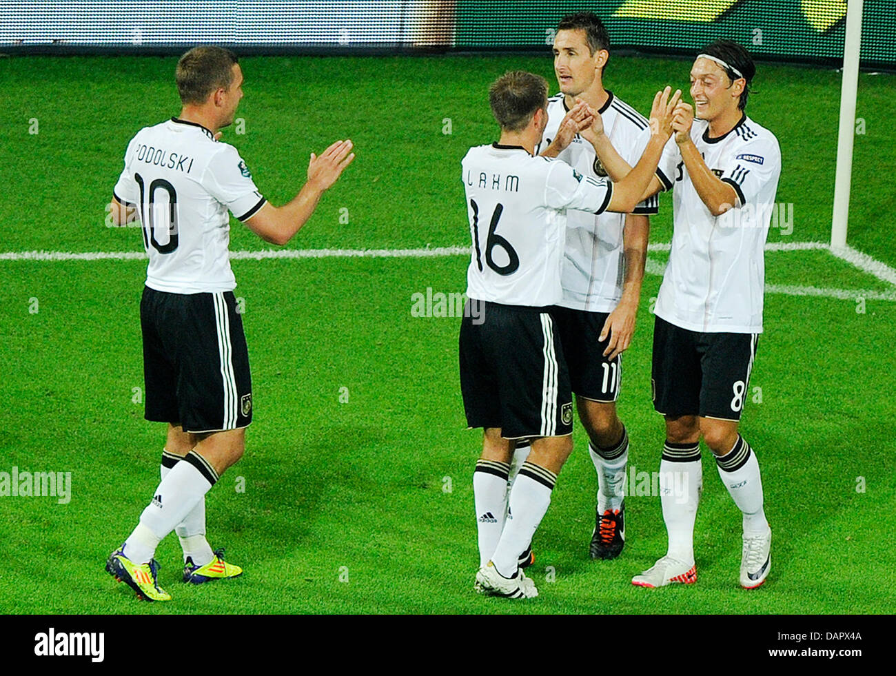 Germanys lukas podolski celebrates scoring hi-res stock photography and ...