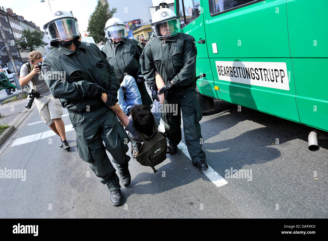 Police officers carry away a protester who took part in a sit-in ...