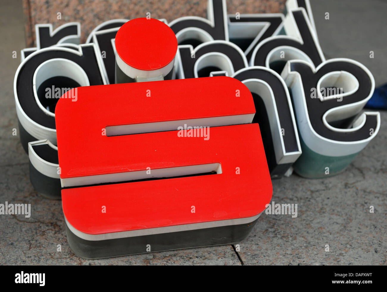 A Sparkasse logo stands in front of a number of single letters on the ...