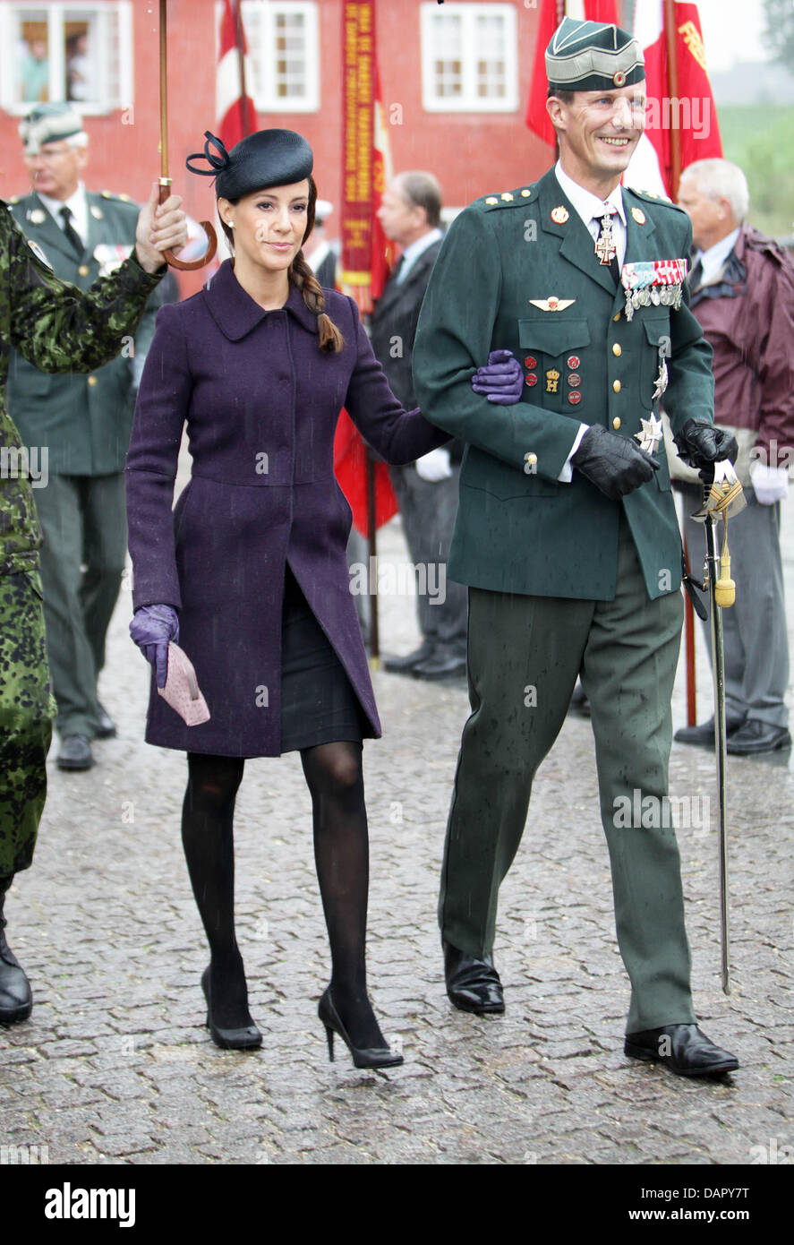 Danish Prince Joachim and Danish Princess Marie arrive in the rain to ...